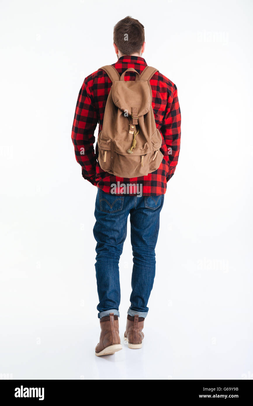 Back view portrait of a casual man with backpack standing isolated on a ...