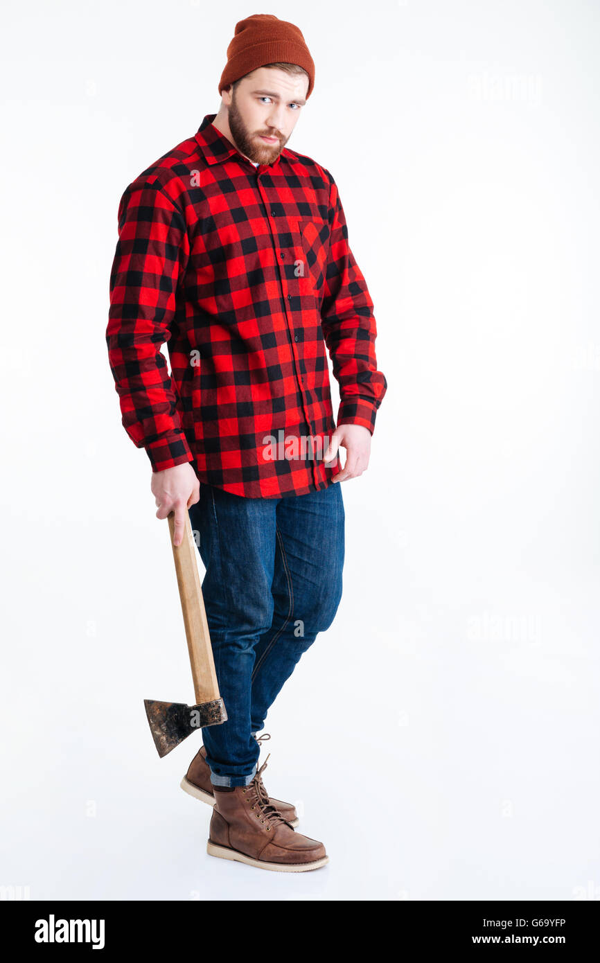 Young hipster guy holding axe and looking at camera isolated on the ...