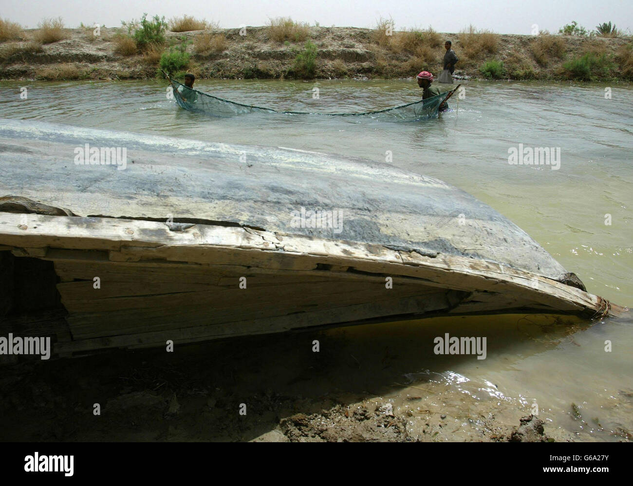 Shia fishermen drag their net through a canal near Al Qurna, Iraq, in ...