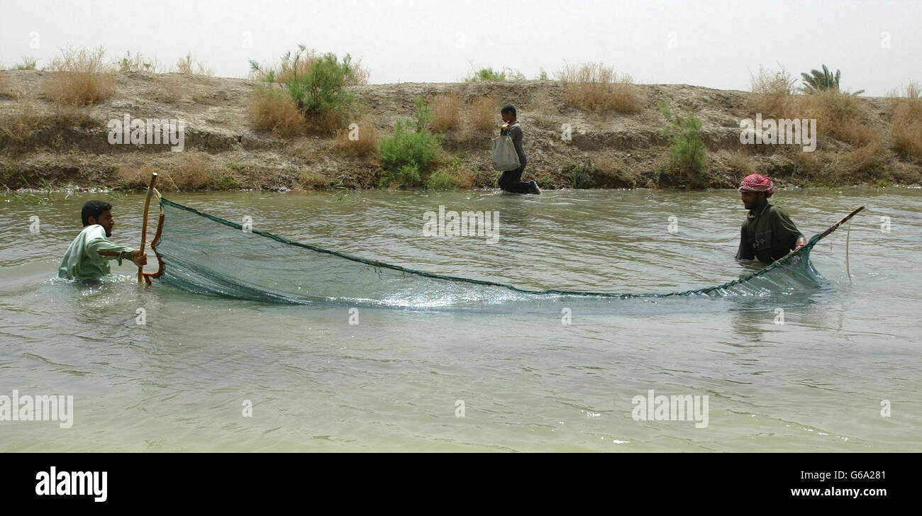 Shia fishermen drag their net through a canal near Al Qurna, Iraq, in ...