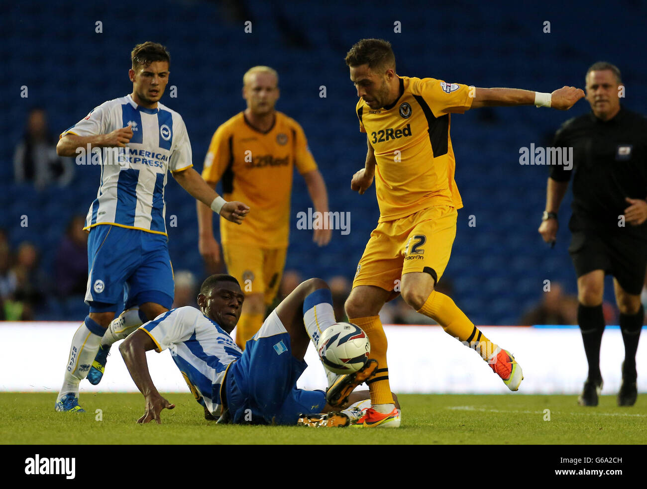 Newport's Robbie Willmott (right) is challenged by Brighton's Rohan ...