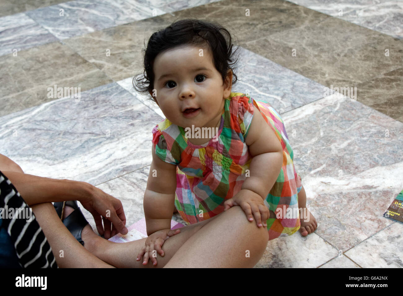 A baby attending a concert with her parents in Battery Park City, a ...