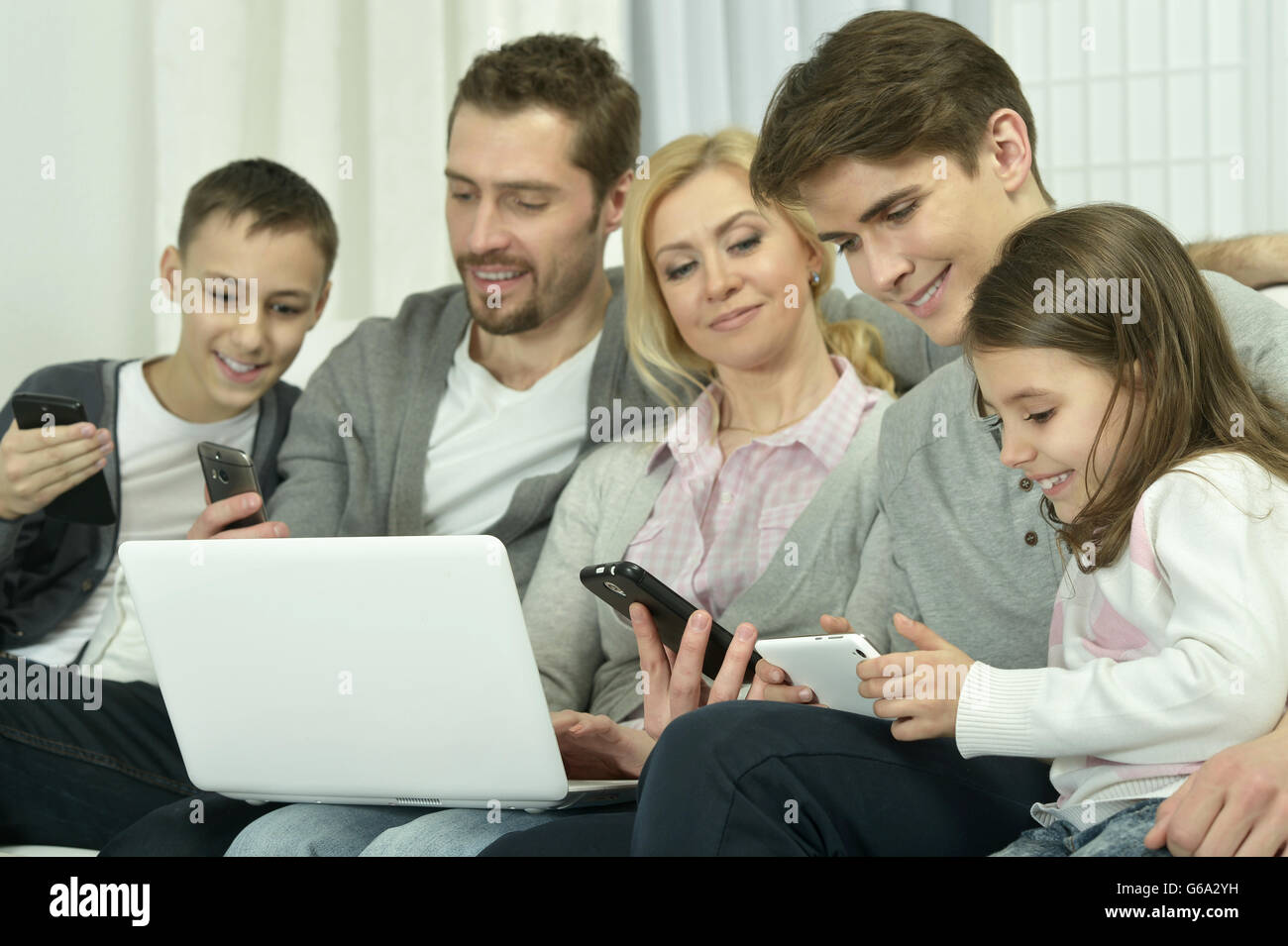 happy family with electronic gadgets Stock Photo - Alamy