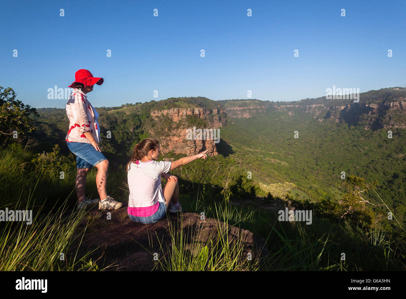 Hiking hikers women mother daughter exploring overlooking wilderness ...