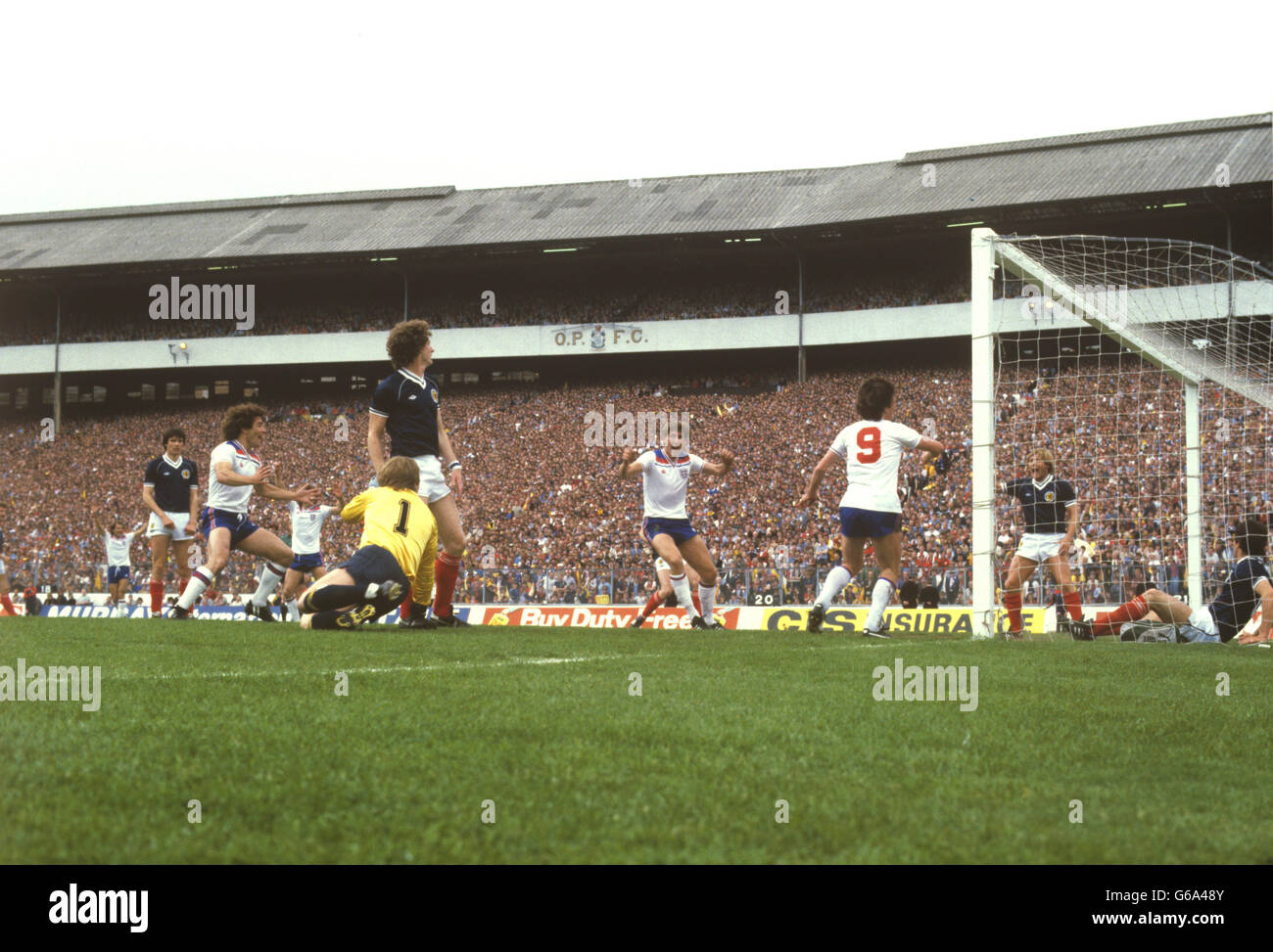 Scotland goalkeeper Alan Rough lies on the ground as Paul Mariner (No 9 ...