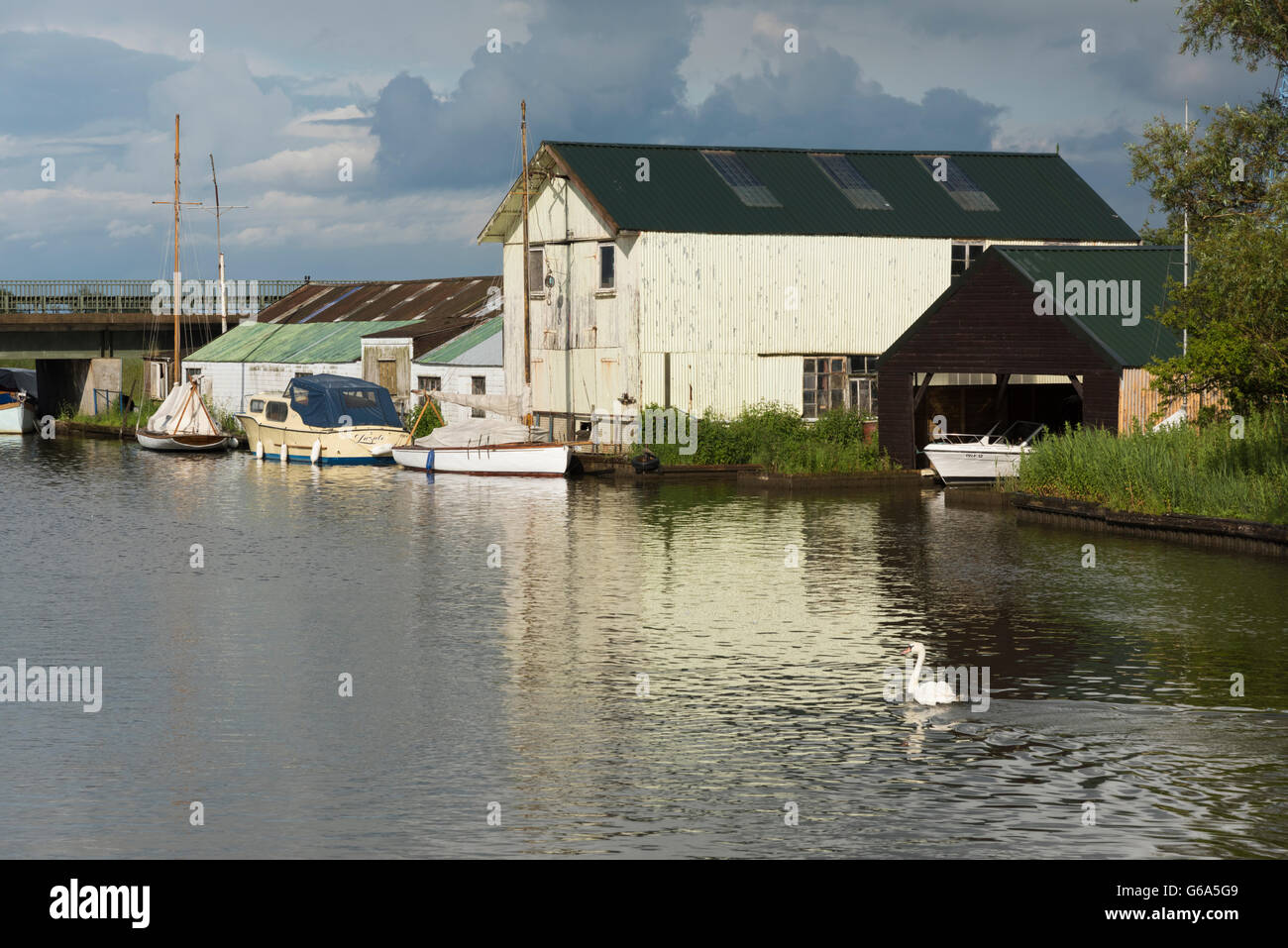 A boat yard at Ludham Bridge the Norfolk Broads UK withrain clouds ...