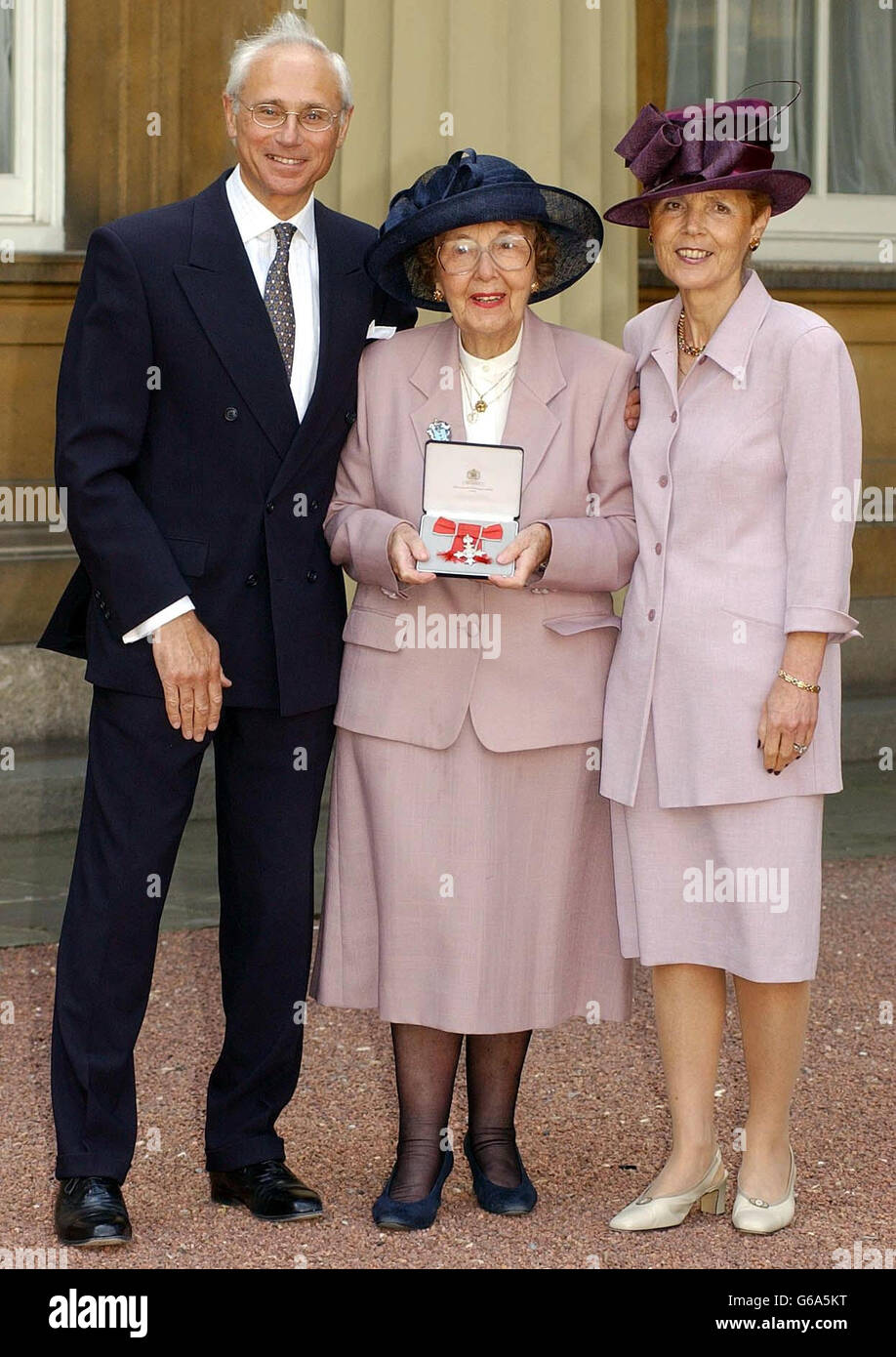 Stella Lucas from London, holds her MBE with her daughter Susan Starr ...