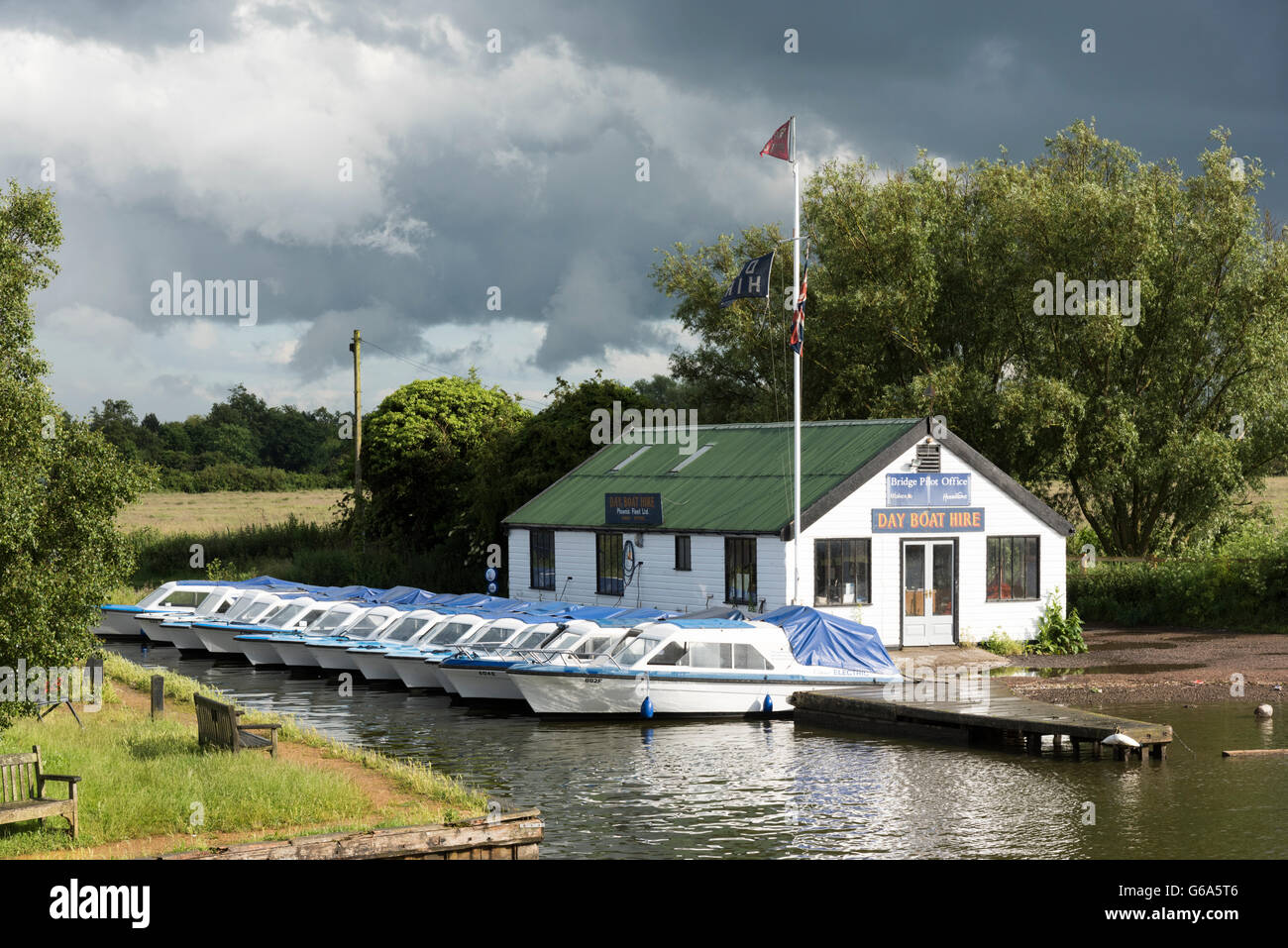 A boat yard at Wroxham in the Norfolk Broads UK withrain clouds ...