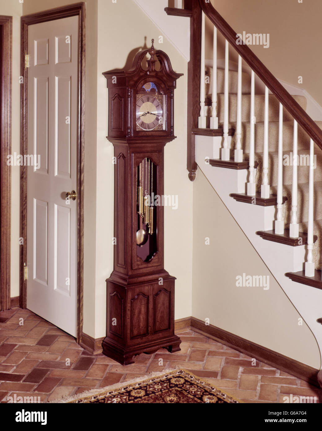 GRANDFATHER CLOCK IN FOYER BY STAIRWAY Stock Photo - Alamy