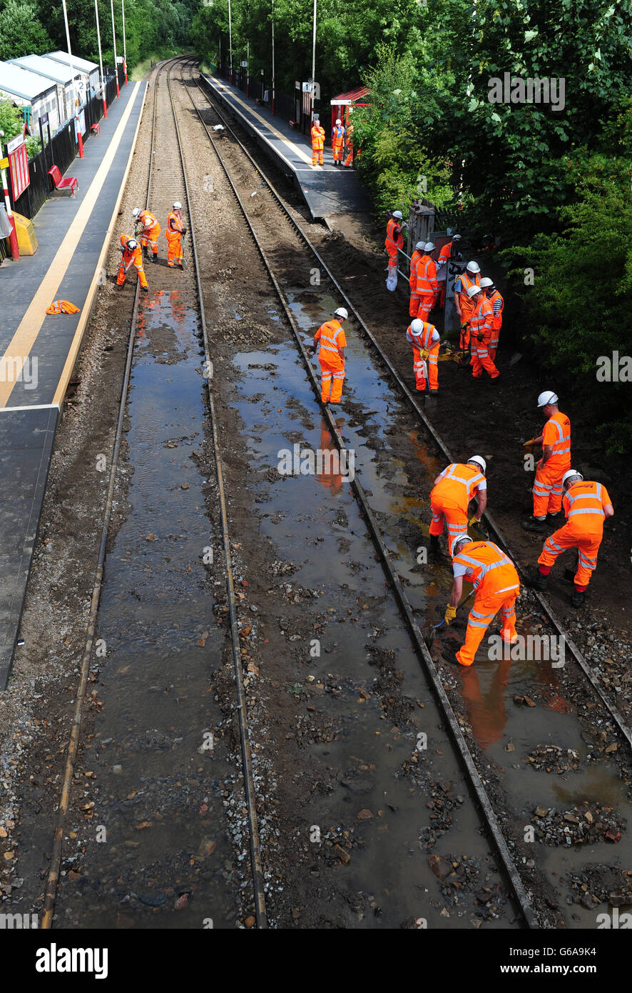 Engineers examine the damage left by flash floods in Walsden, near ...