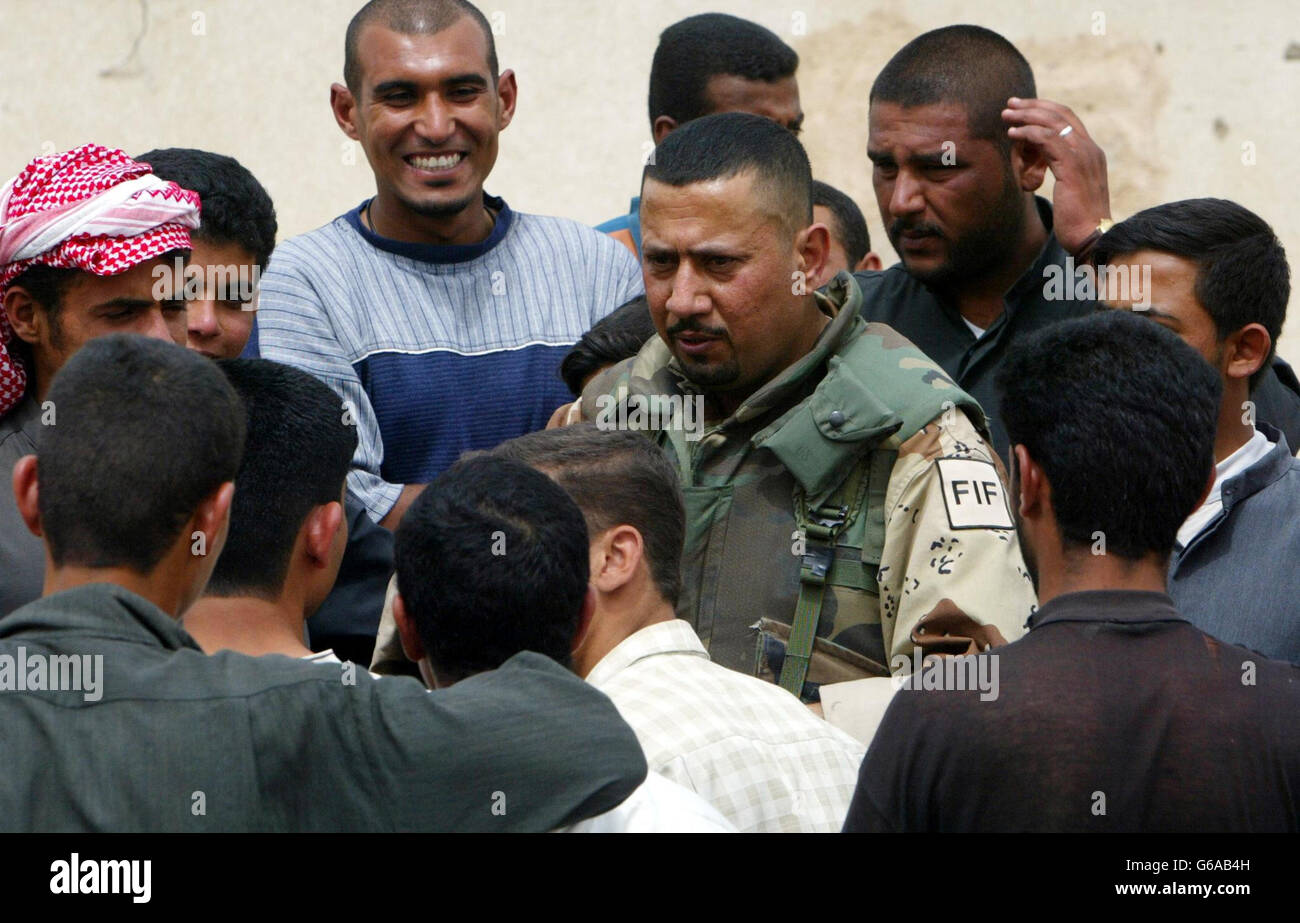 Ali Sadoun Salmon (Centre), from the Free Iraqi Force talks with the ...