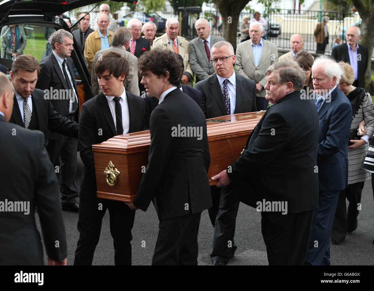 Fellow RTE presenter Joe Stack (back left) carries the coffin of Colm ...