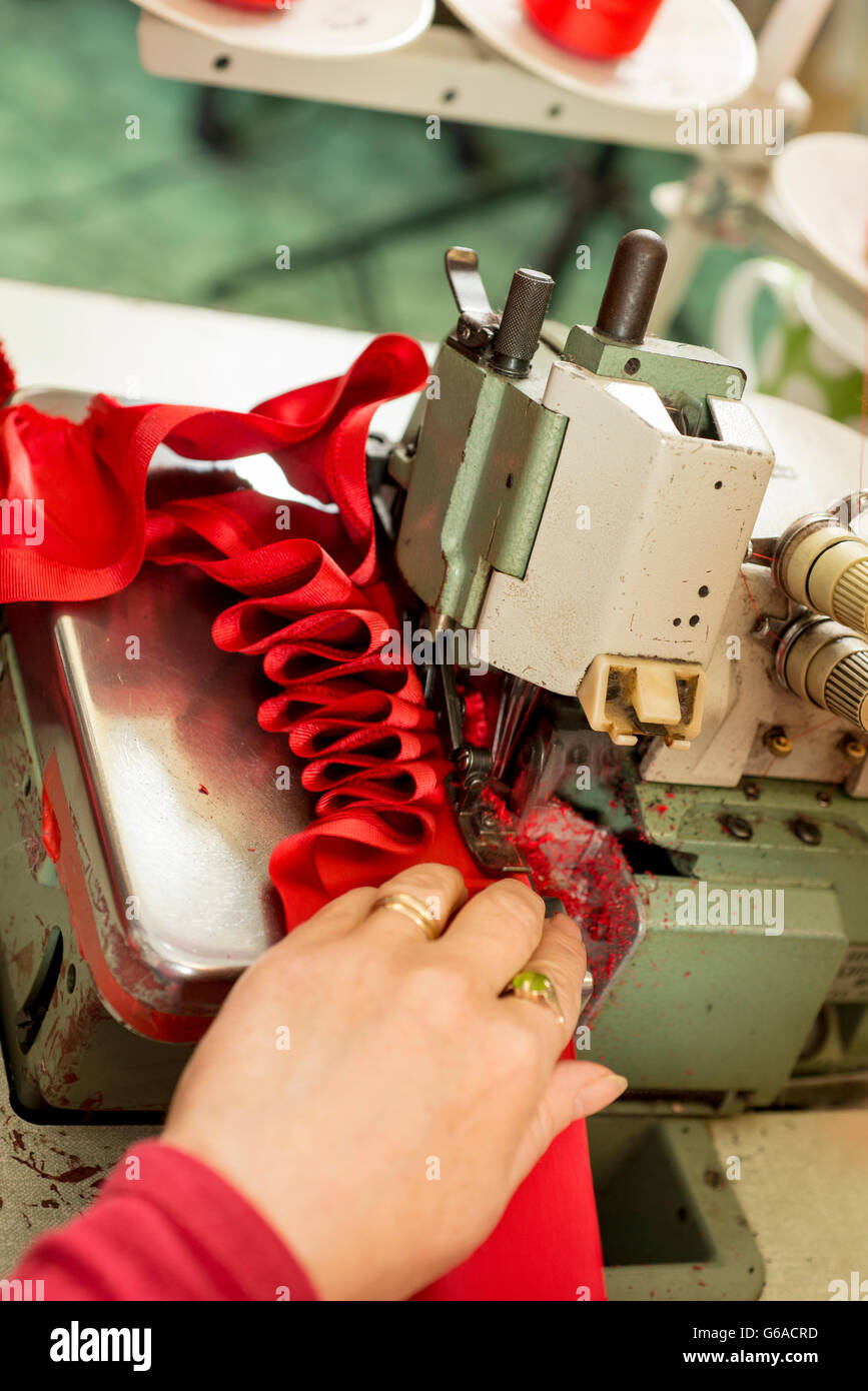 Red cloth stitched and ruffled through a sewing machine Stock Photo - Alamy