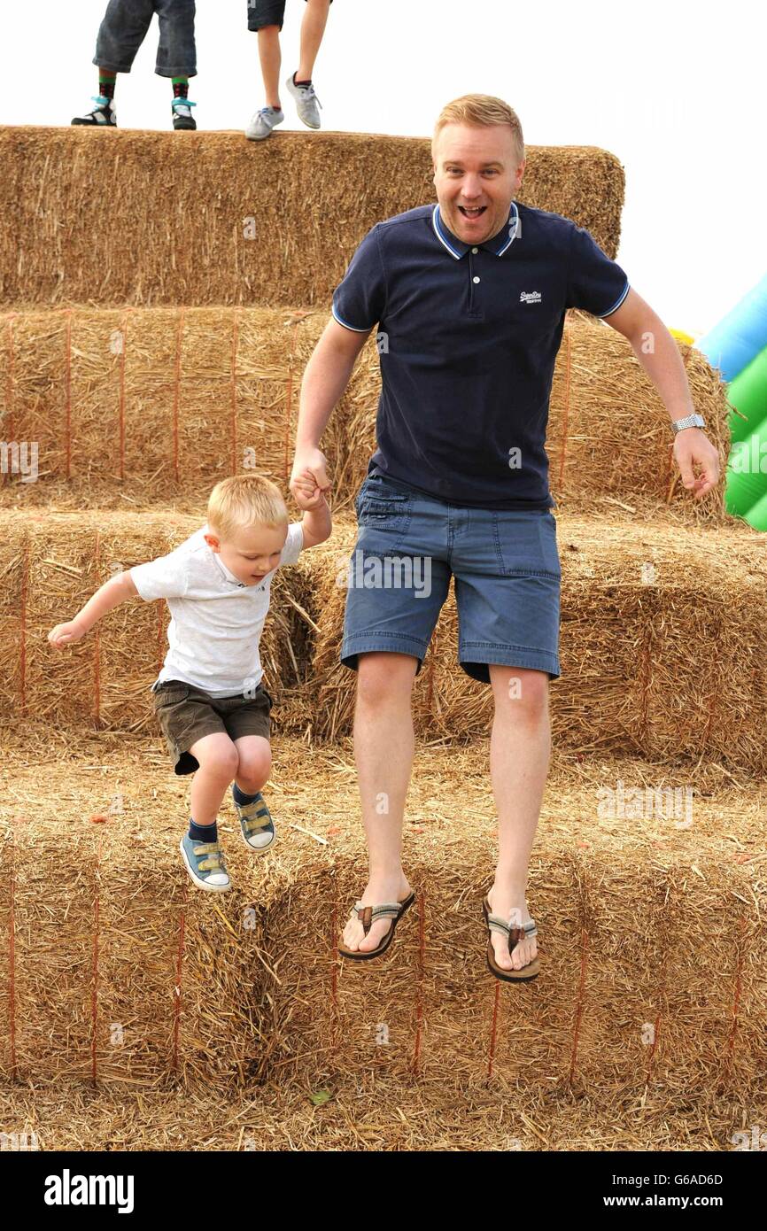 Harry Roach, aged 3, enjoys the sunny weather, with his father Darren ...