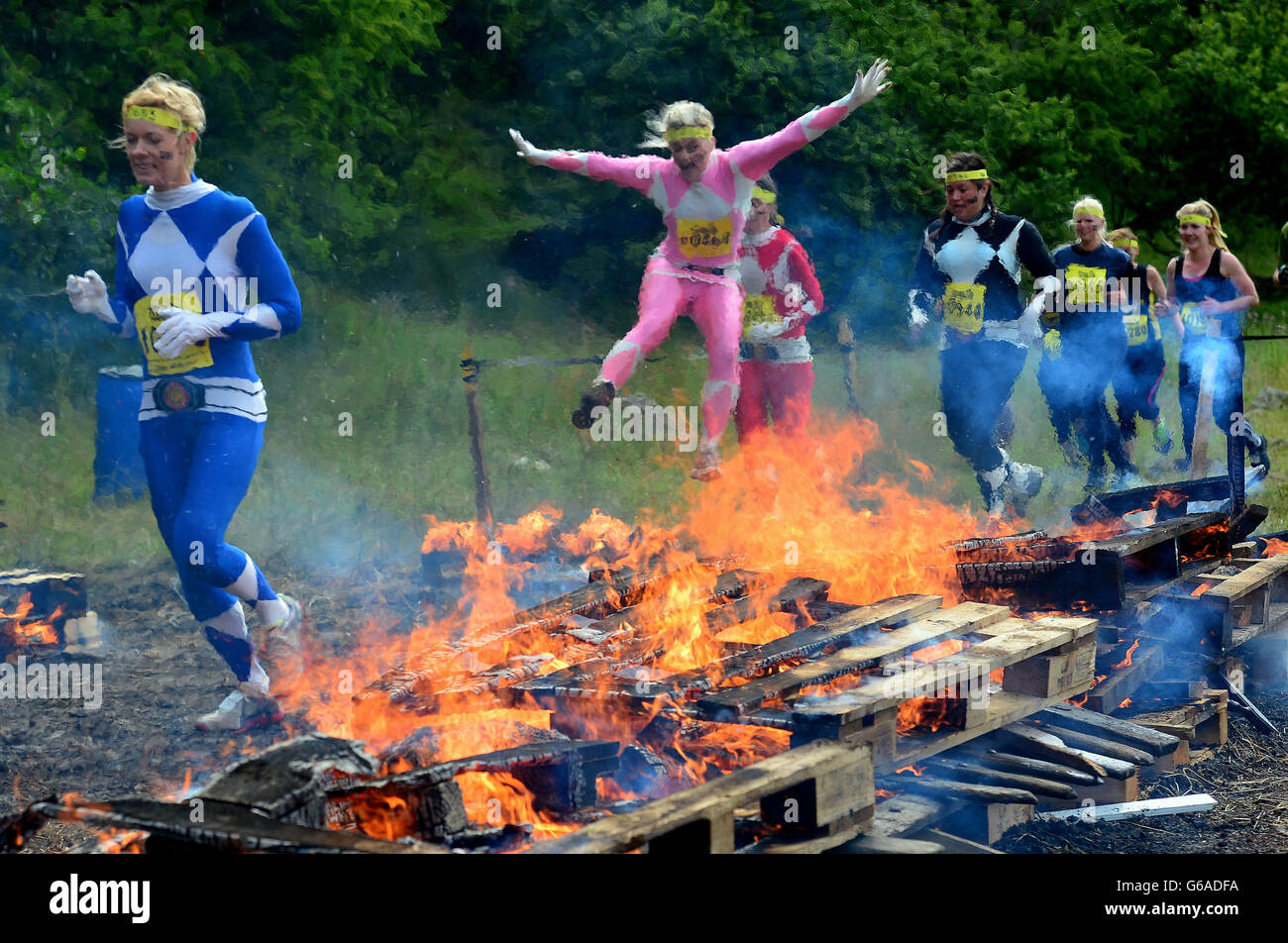 Competitors jump through flames on the 'Human BBQ' section of the Total ...