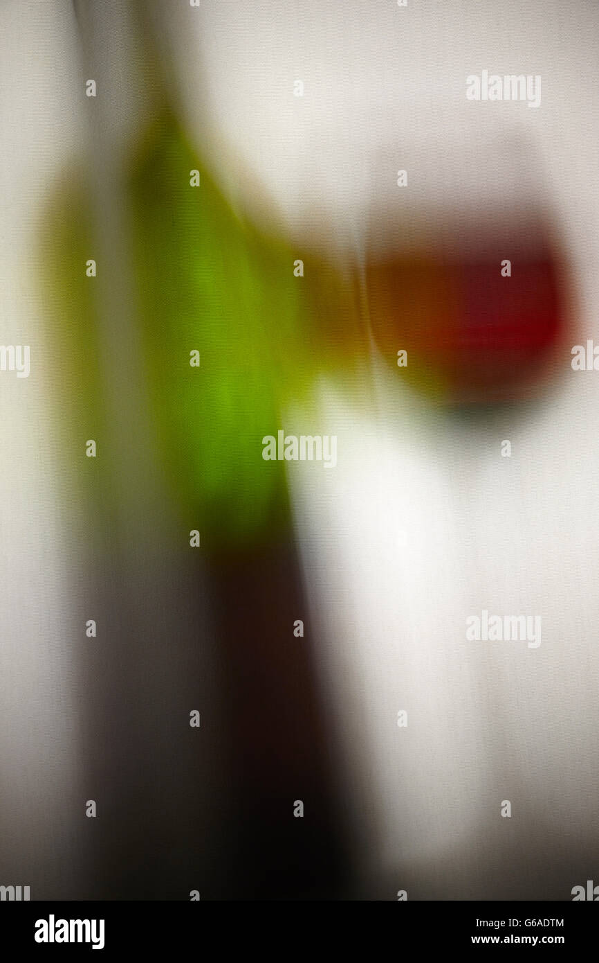 Reflection of a bottle and a cup of red wine. Vertical format Stock ...
