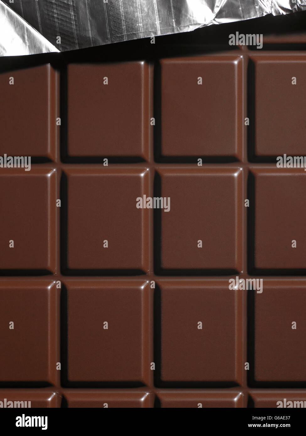 Dark chocolate bar with aluminium foil. Vertical format Stock Photo - Alamy