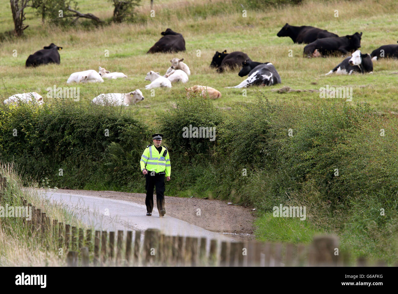 A police officer near the Meadowhead Farm near Auldhouse where two ...