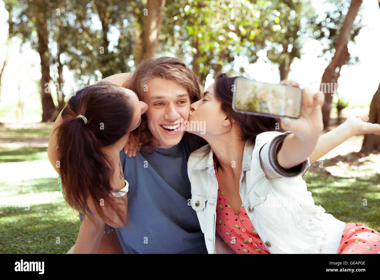 Friends taking selfie together at park Stock Photo - Alamy