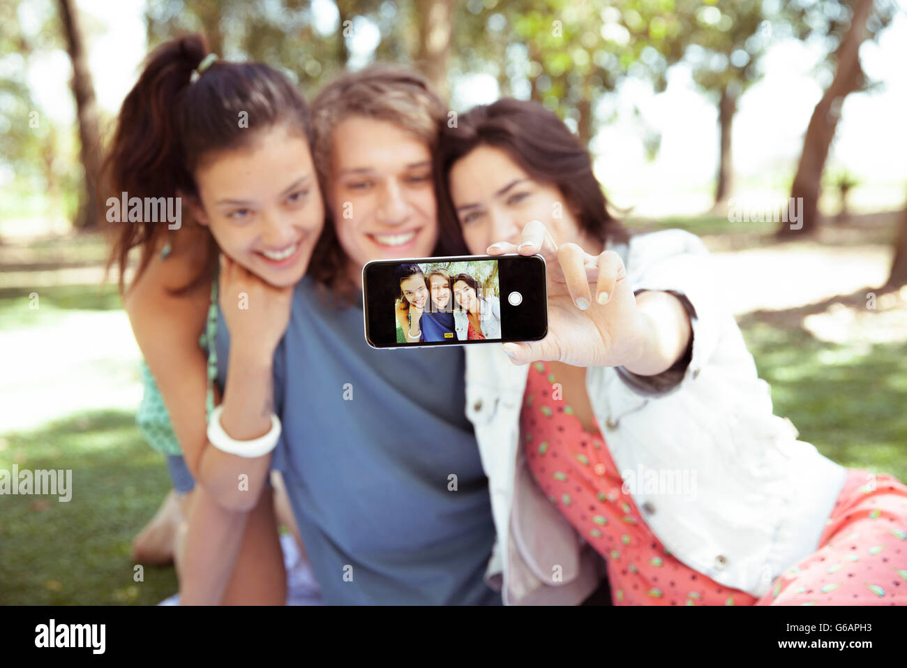 Friends taking selfie together at park Stock Photo - Alamy