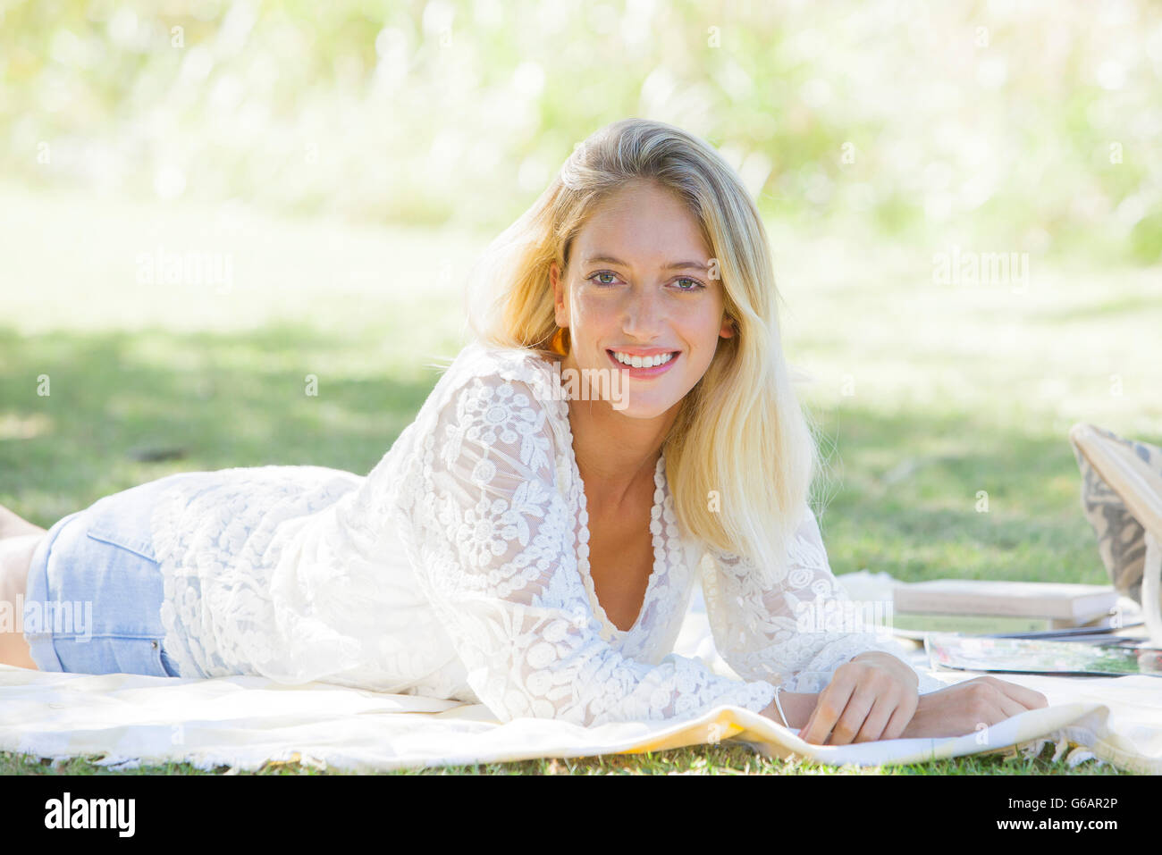 Woman sunbathing on grass lawn hi-res stock photography and images - Alamy