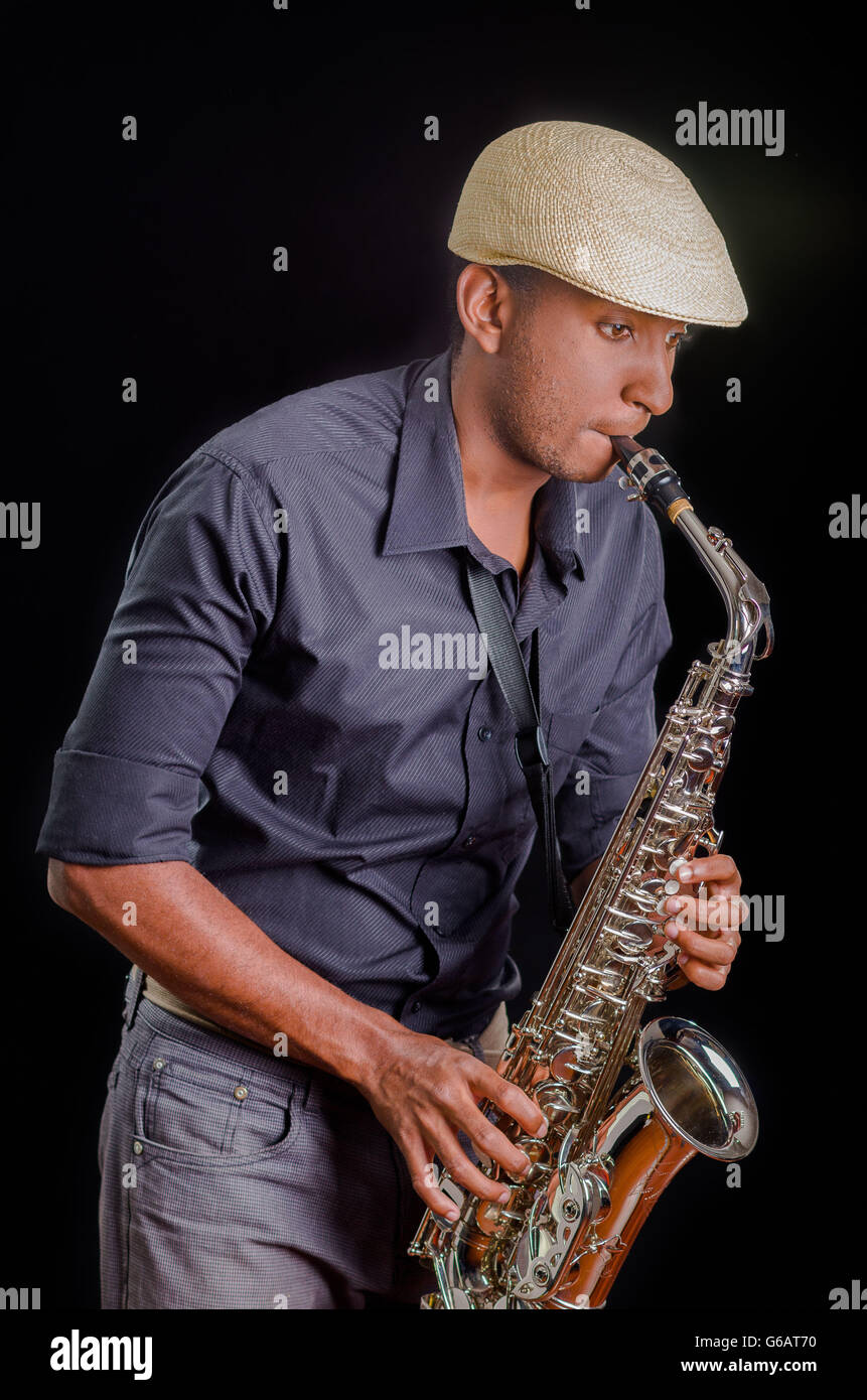 In a dark background man playing his saxophone, passion music Stock ...