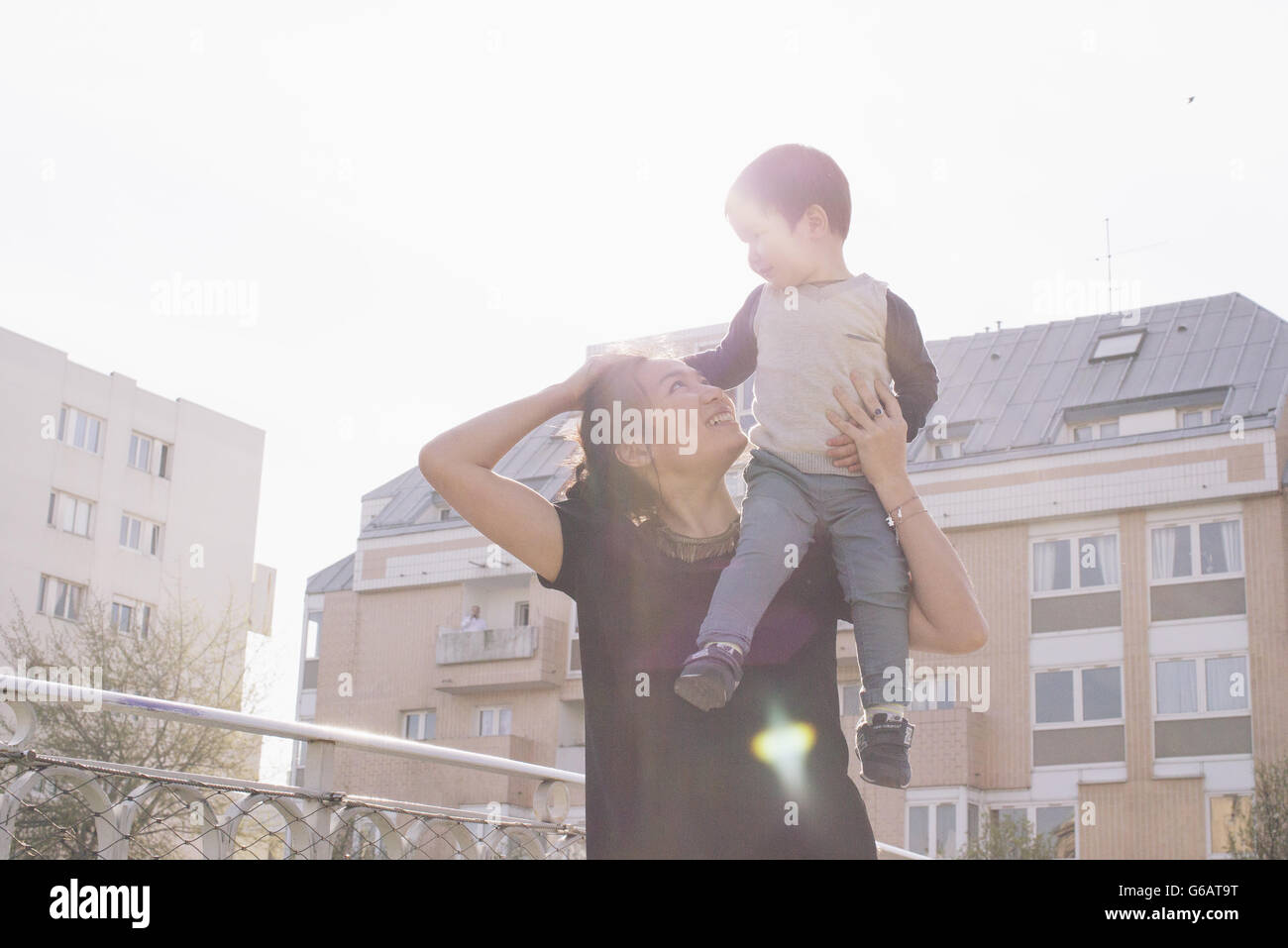 Mother carrying little boy on shoulder Stock Photo - Alamy