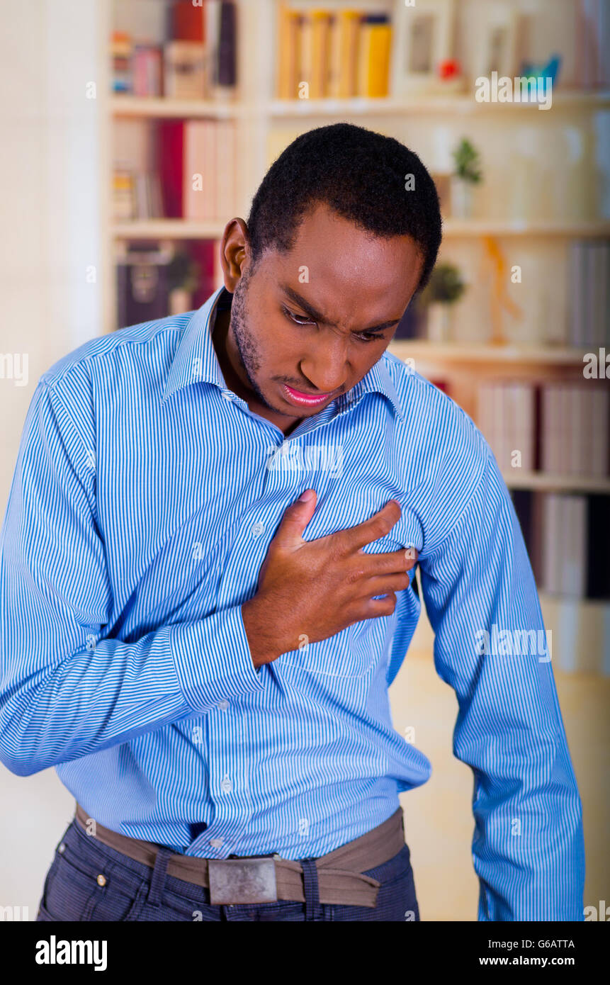 Stand up boy stopped, heart pain in his chest. Hand touching his chest ...