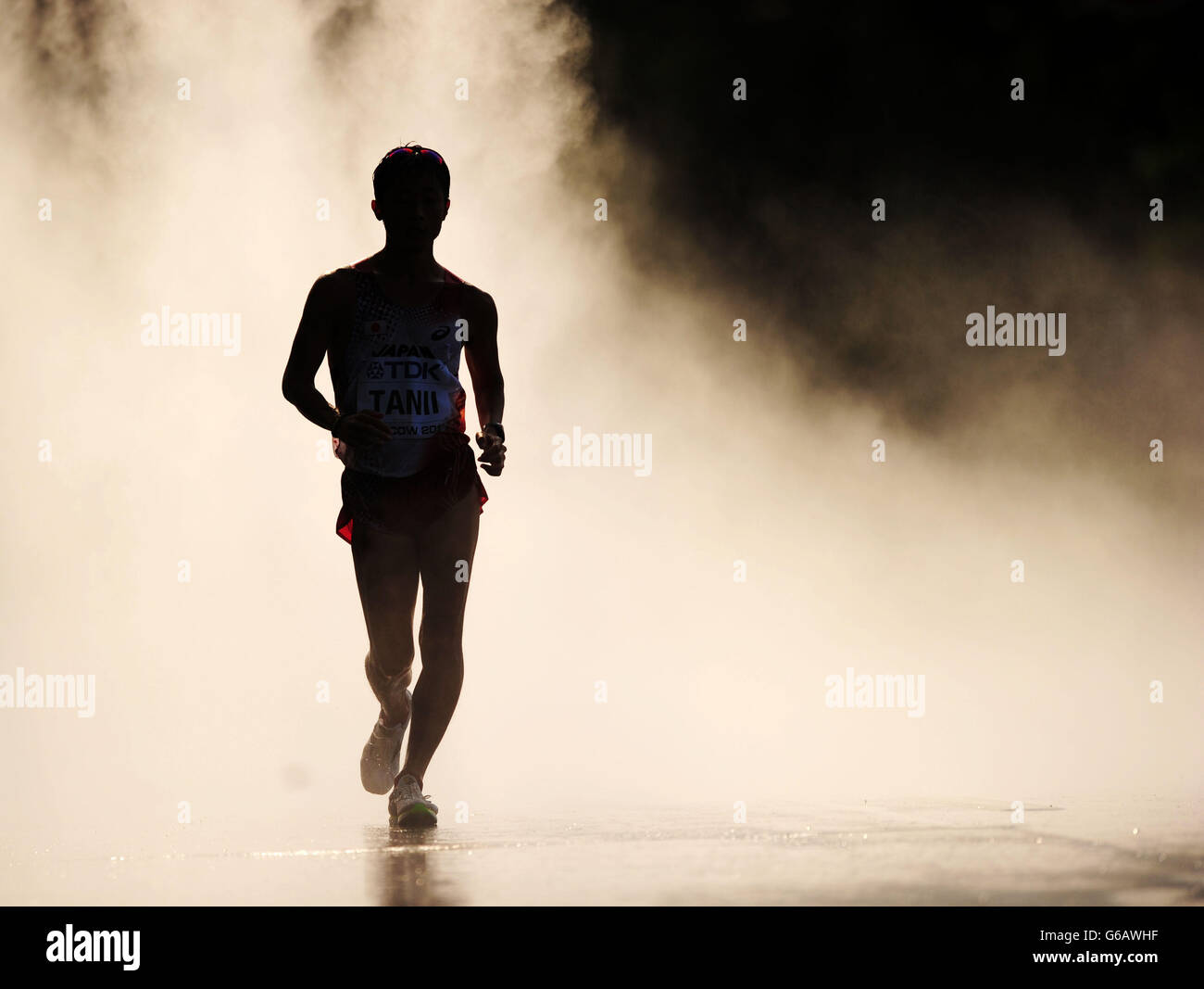 A competitor goes through the shower in the Men's 50km Race Walk during ...