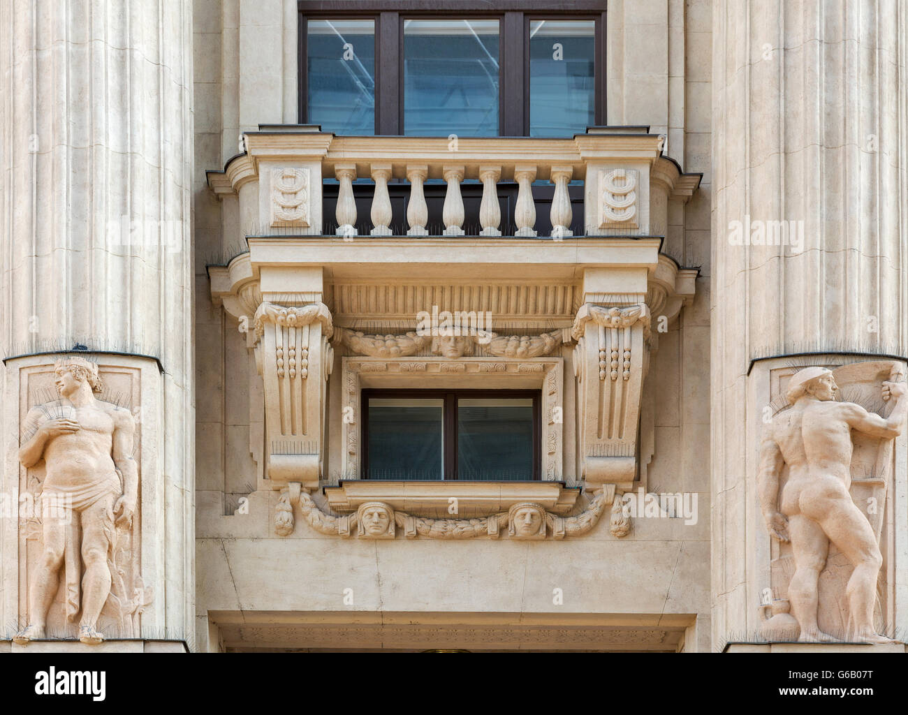 Old building exterior with balcony, columns and bas relief closeup ...