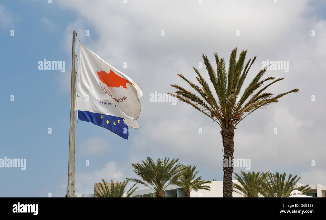 Flags of Cyprus and European Union on Paphos summer resort with palms ...