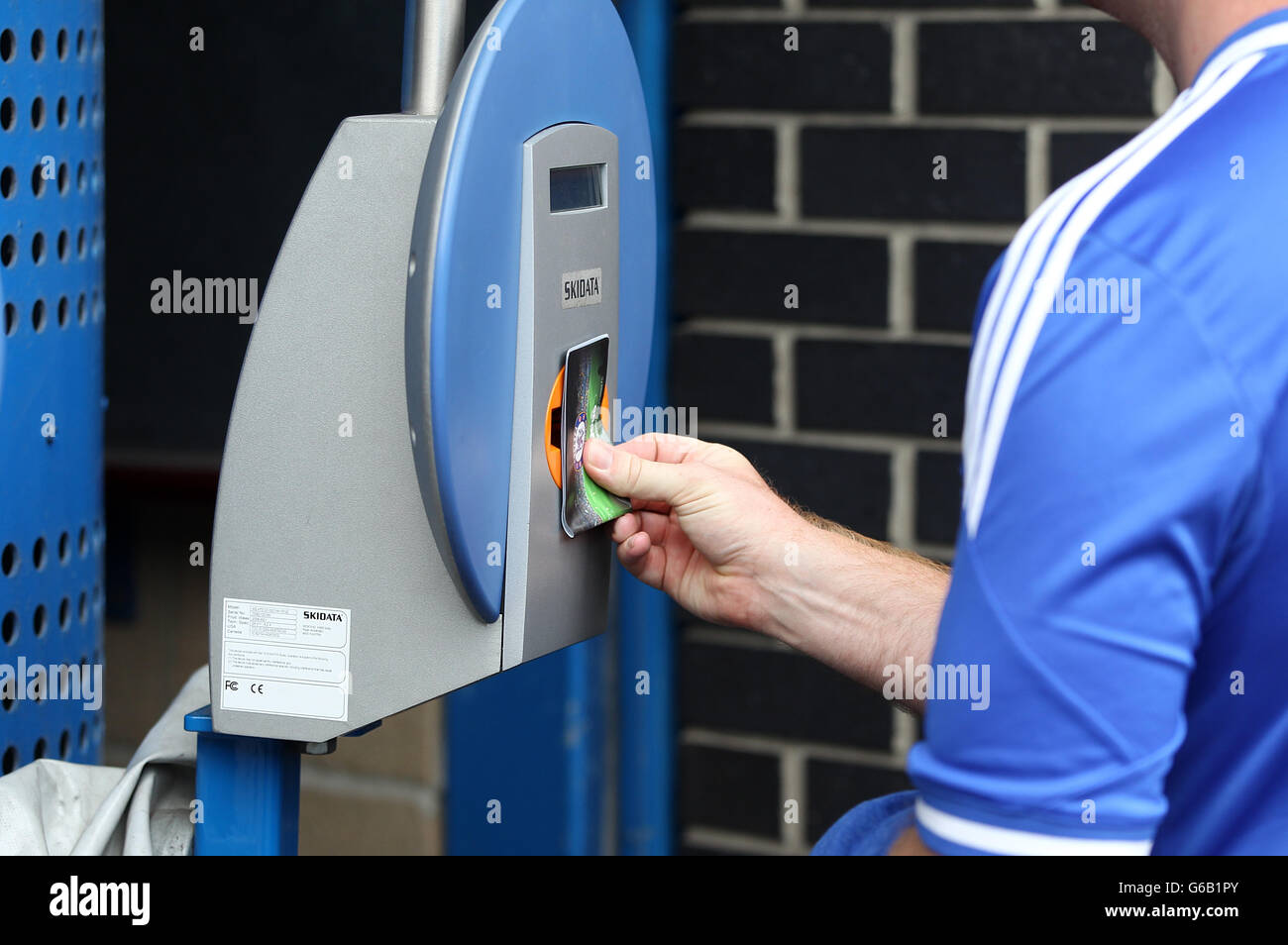 A fan uses the automatic ticket scanning and access system at Stamford ...