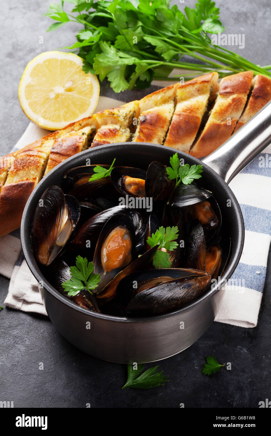 Mussels and homemade bread on stone table Stock Photo - Alamy