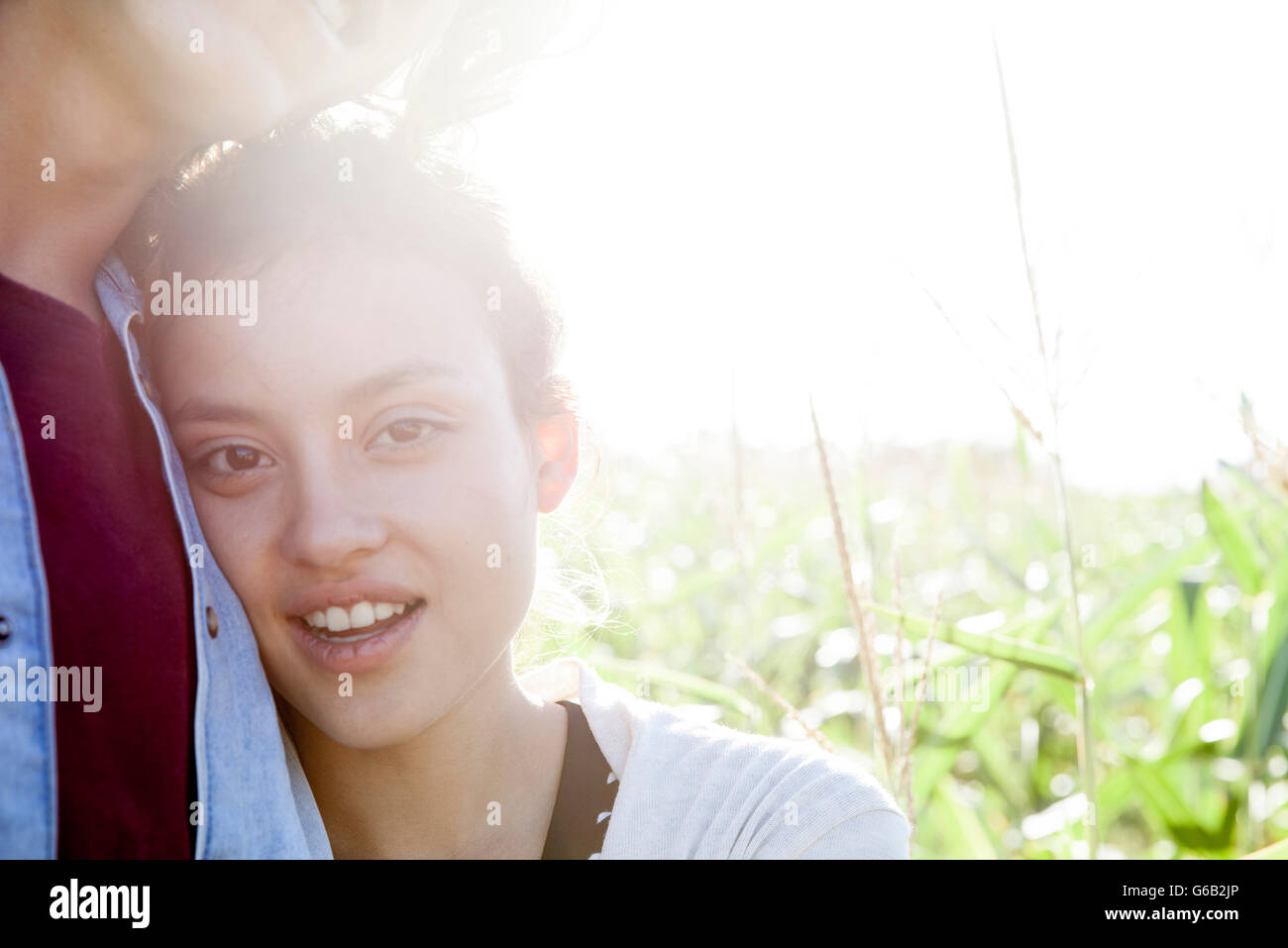 Young woman resting head against boyfriend's chest Stock Photo - Alamy