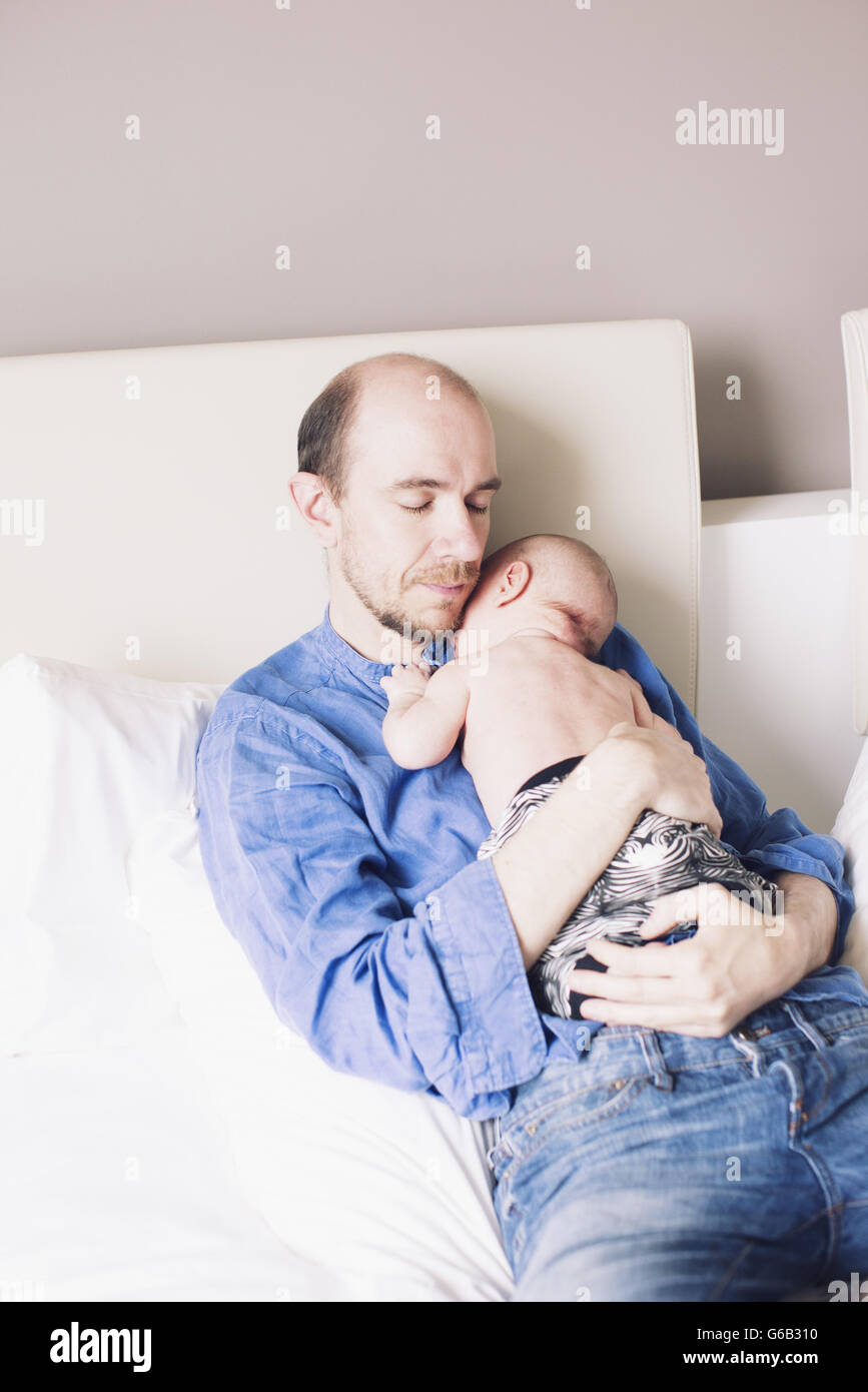 Father napping with infant Stock Photo - Alamy