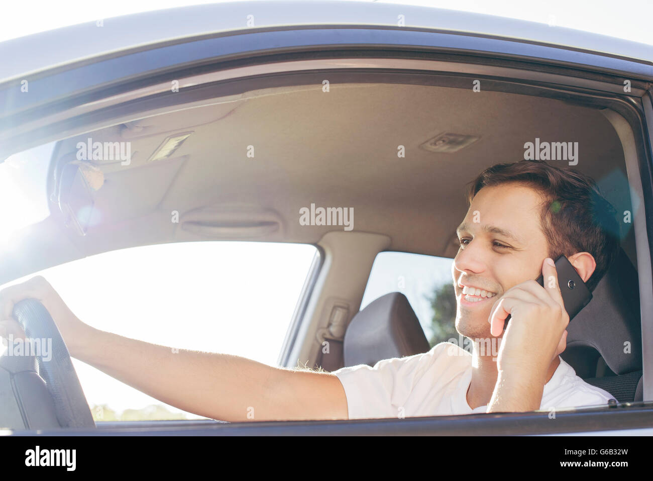 Man chatting on phone while driving Stock Photo - Alamy