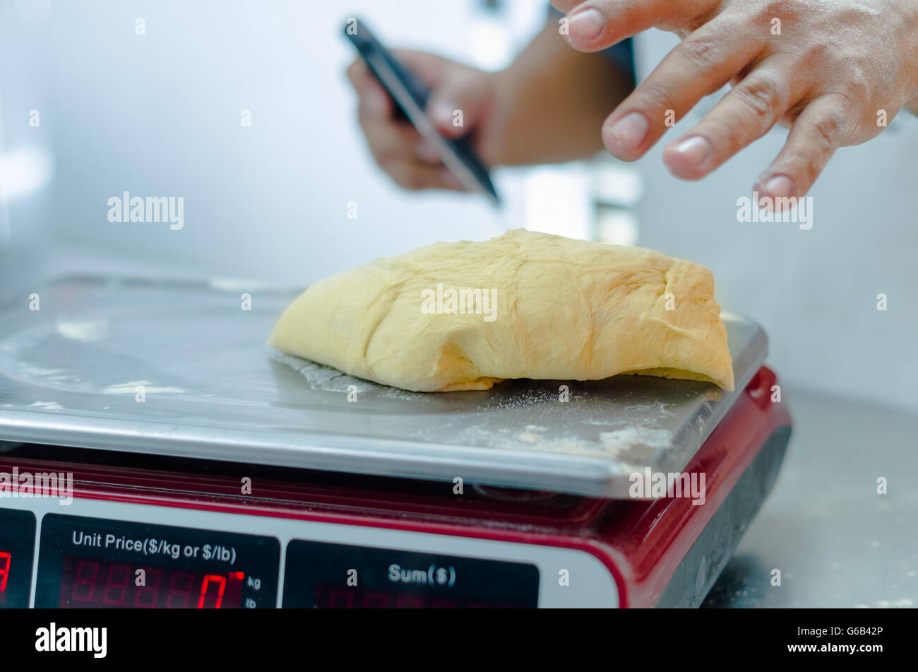 Bakers hands working and weighing bread dough on digital scale Stock ...
