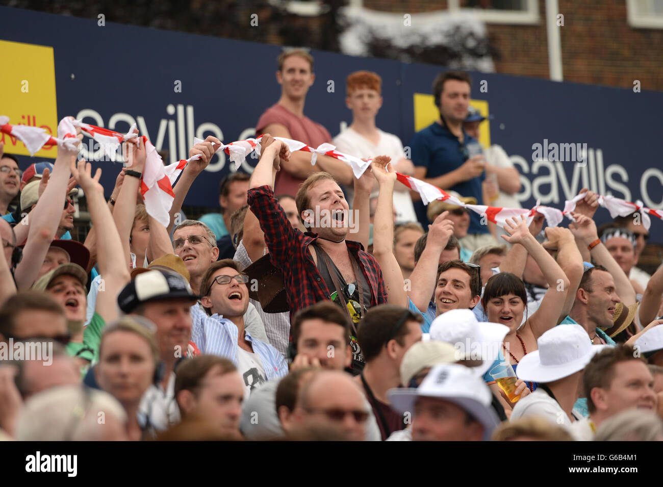 Fans with a St George's flag train soak up the atmosphere at the Kia ...
