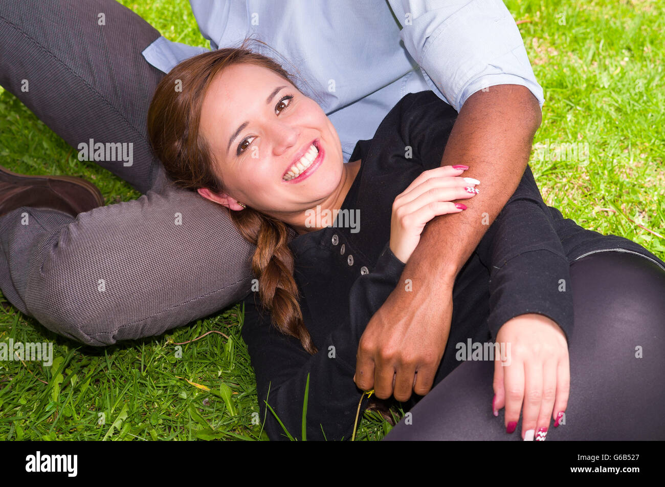 Beautiful young interracial couple in sitting garden environment ...