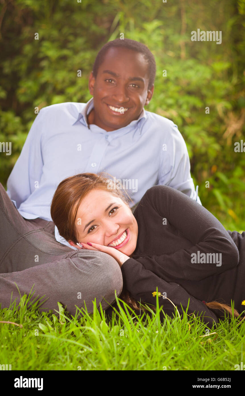 Beautiful young interracial couple in sitting garden environment ...