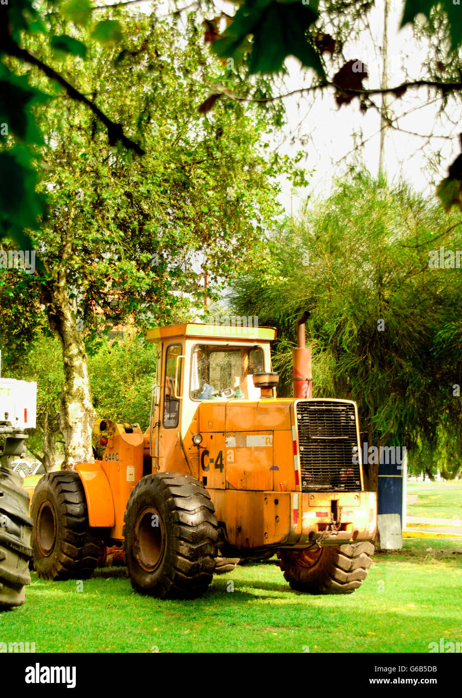 Large yellow bulldozer parked on green grass, very nice color ...