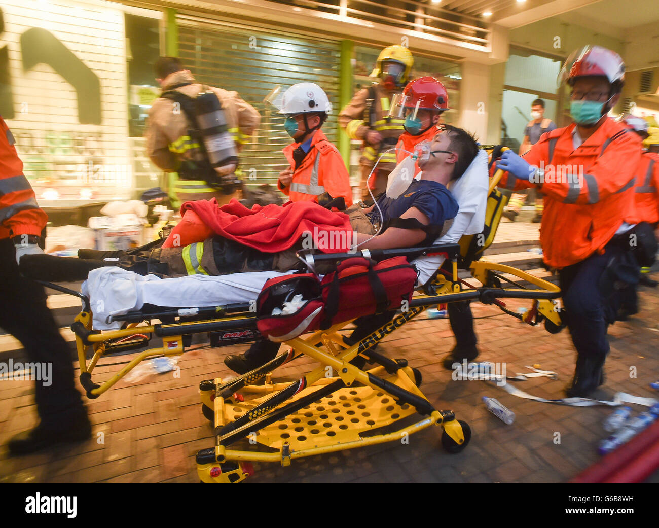 Hong Kong, China. 23rd June, 2016. An injured firefighter is wheeled to ...