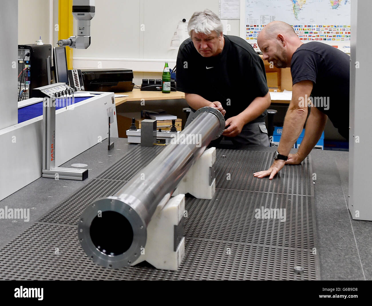 Employees in quality control direct a wave for automatic metering at ...