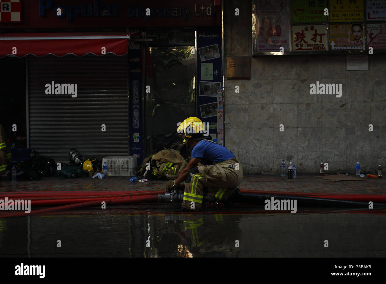 Fire hoses are being extended outside burning building at the ...