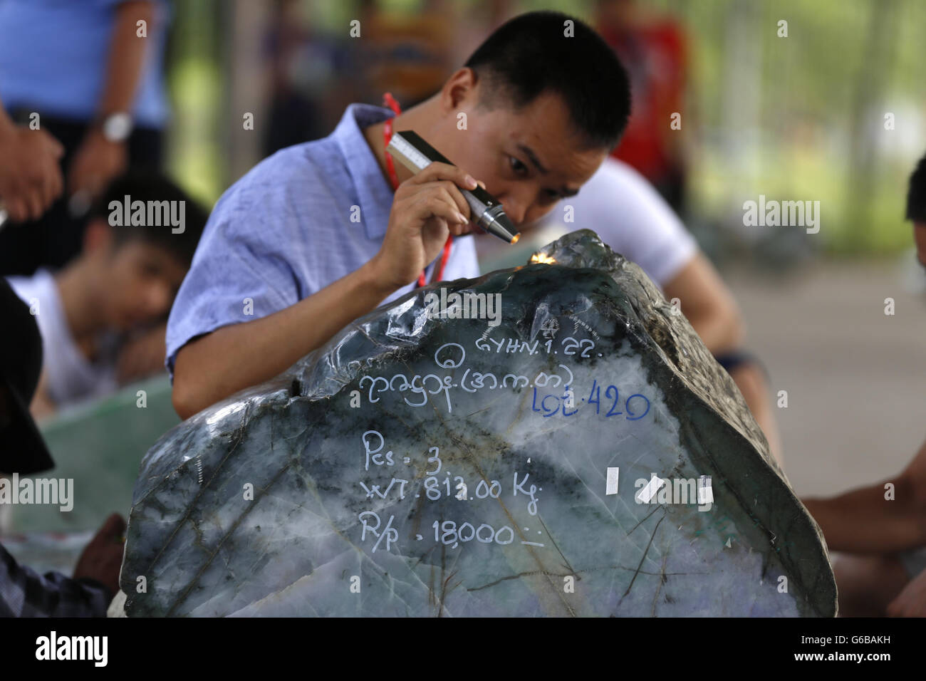 Nay Pyi Taw, Myanmar. 24th June, 2016. A merchant views the jade during ...