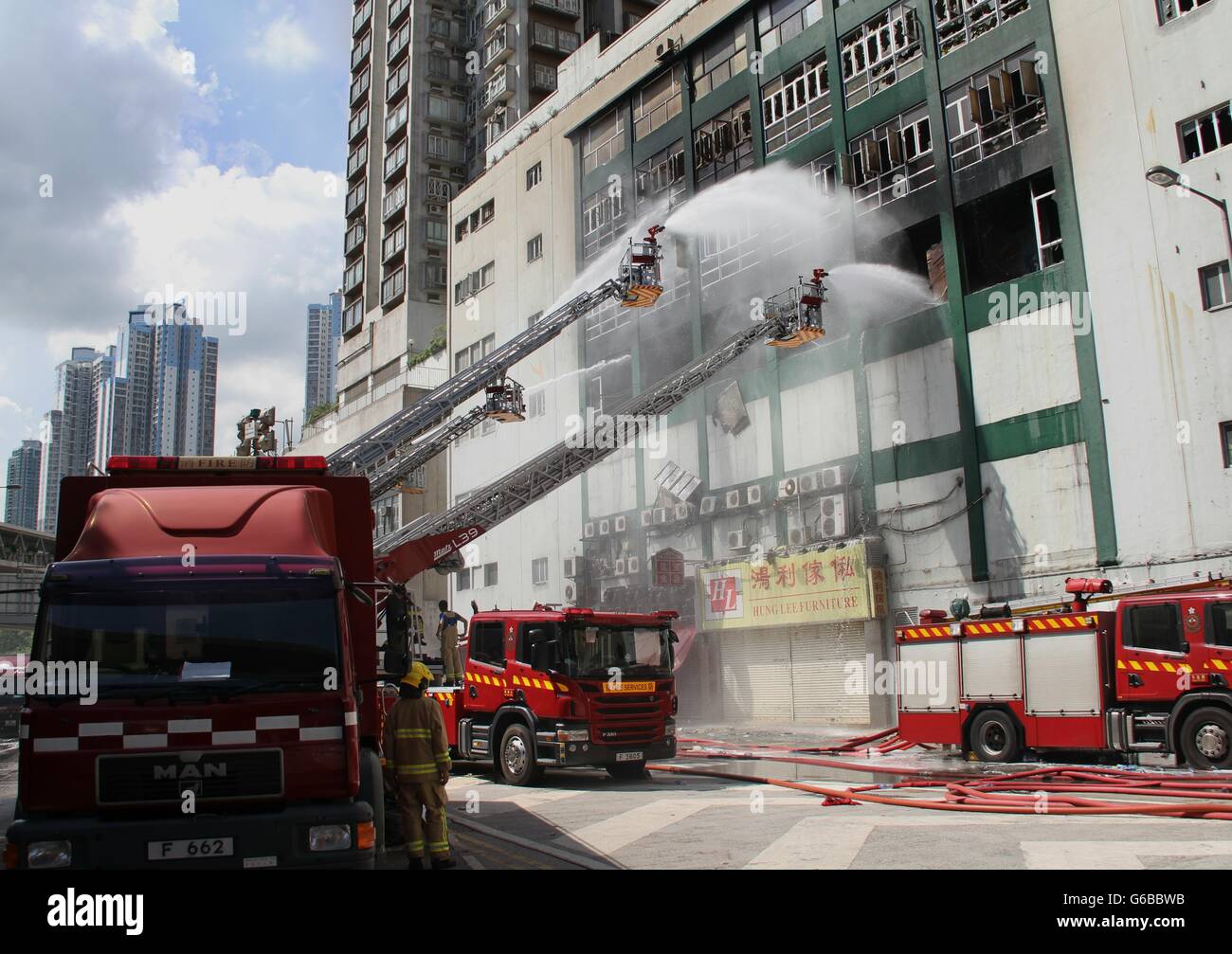 Hong Kong, China. 24th June, 2016. Firefighters put out fire at a multi ...