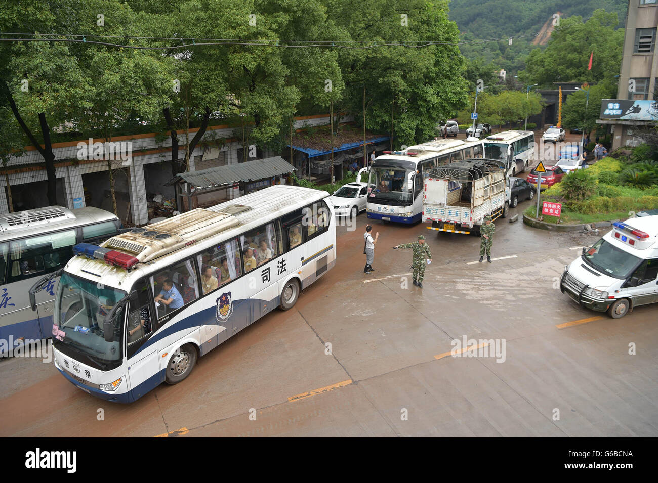 Chongqing, China. 24th June, 2016. Police vehicles carrying prisoners ...
