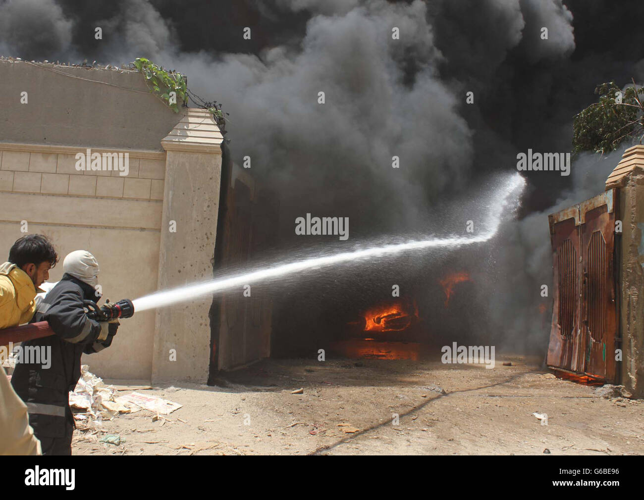 Fire fighters are busy in extinguishing fire that erupted in tyre ...