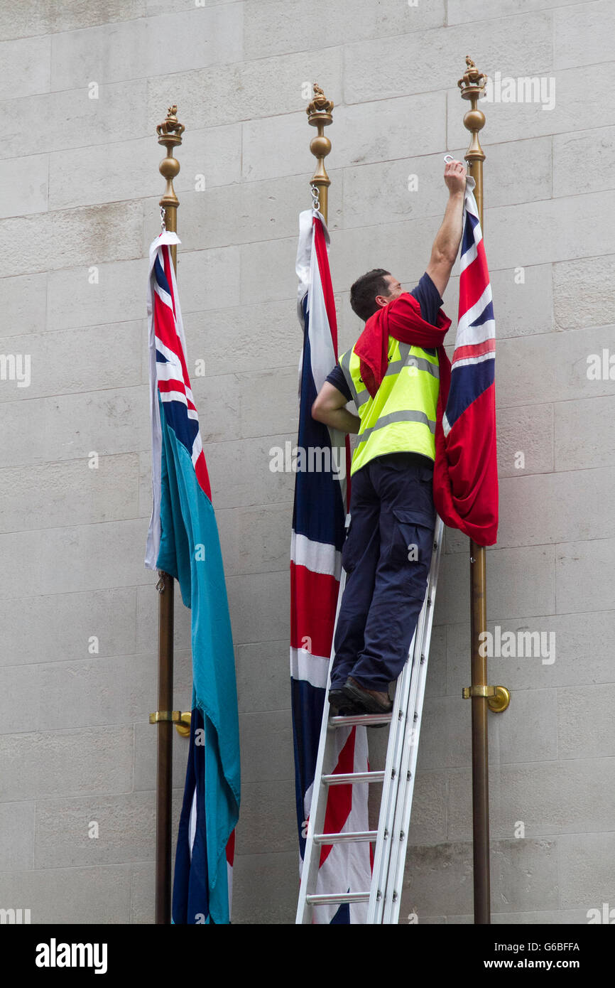 Westminster London,UK. 24th June 2016. A worker on a ladder removes the ...