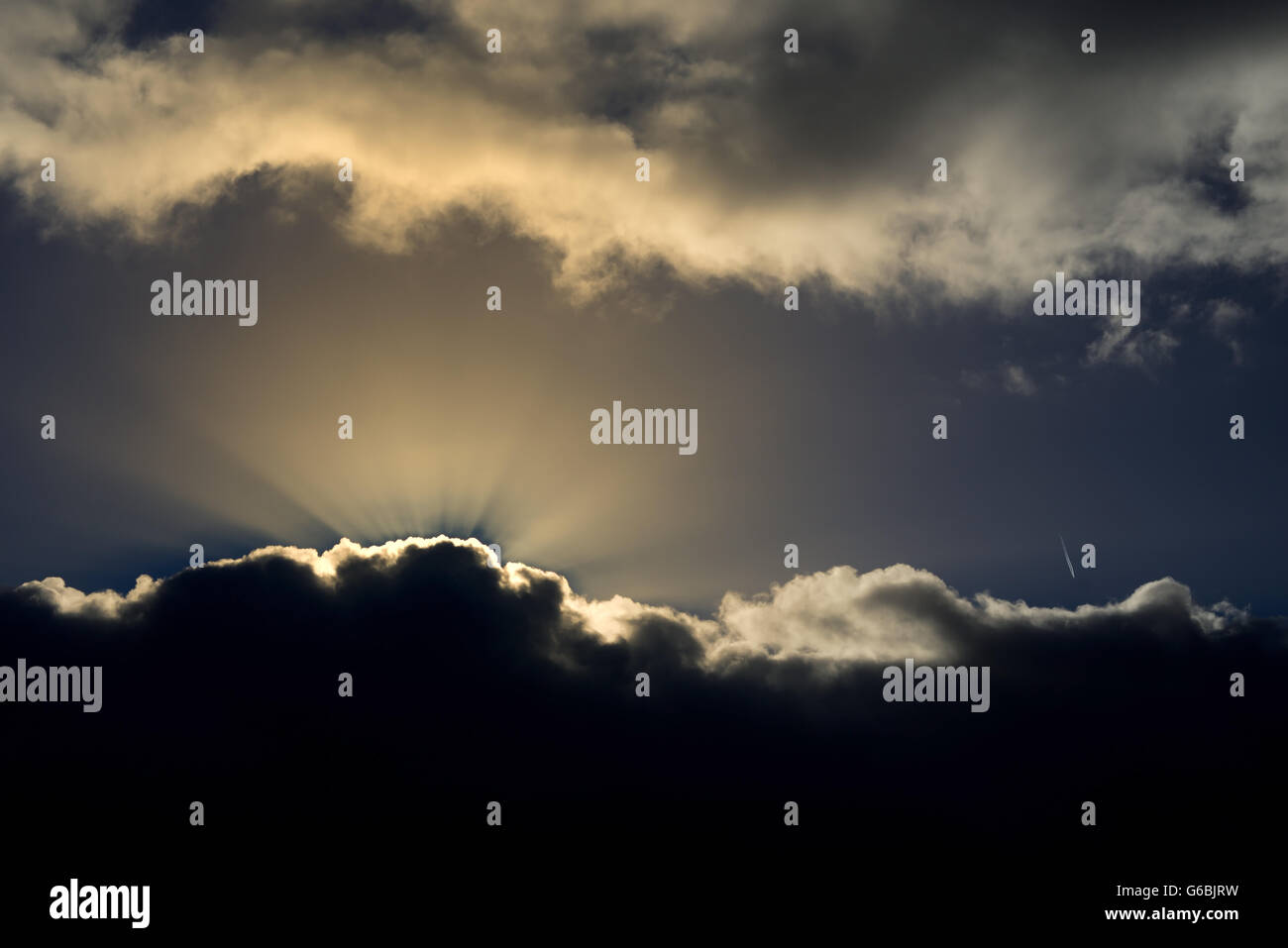 Sunrays from behind clouds hi-res stock photography and images - Alamy